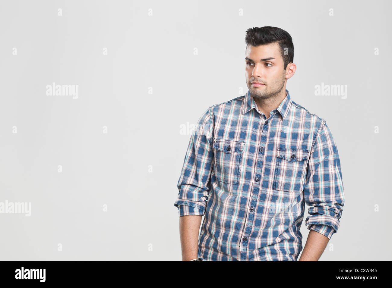 Man standing with hands in pockets Stock Photo - Alamy