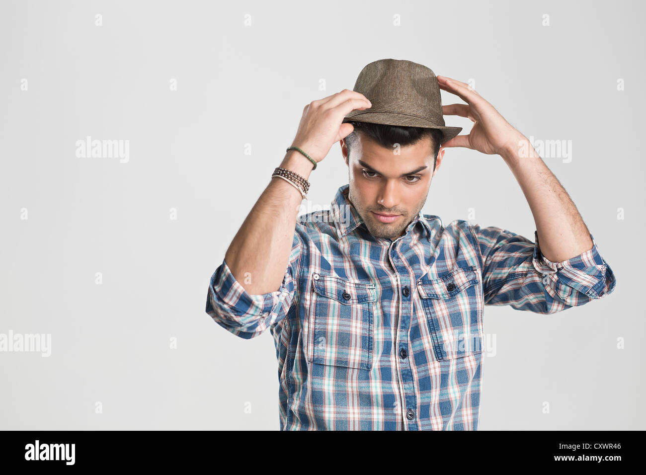 Man trying on hat Stock Photo - Alamy