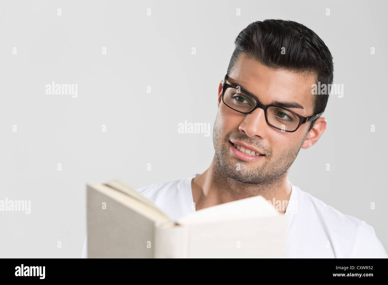 Smiling man reading book Stock Photo - Alamy