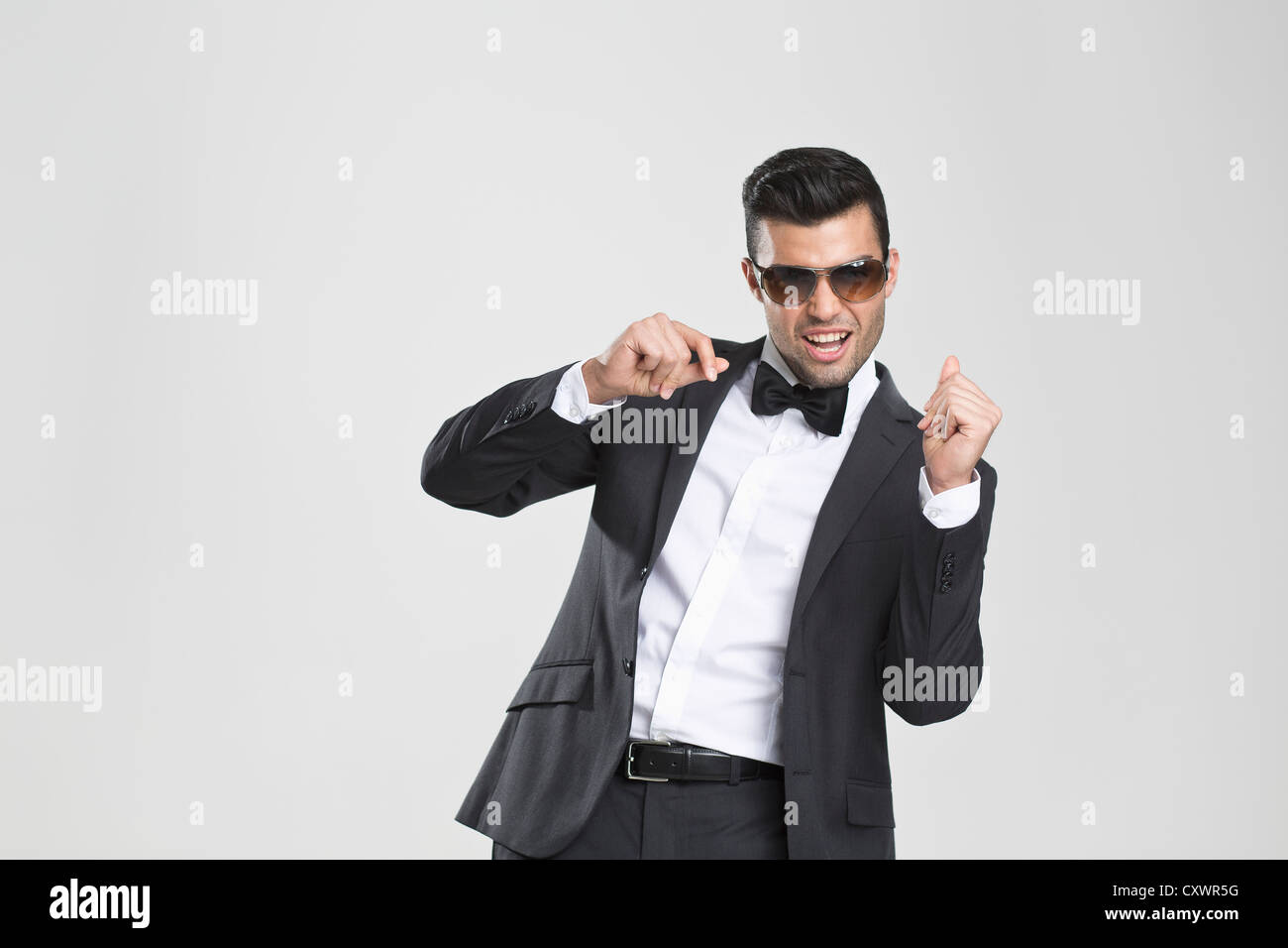 Smiling man in tuxedo dancing Stock Photo - Alamy