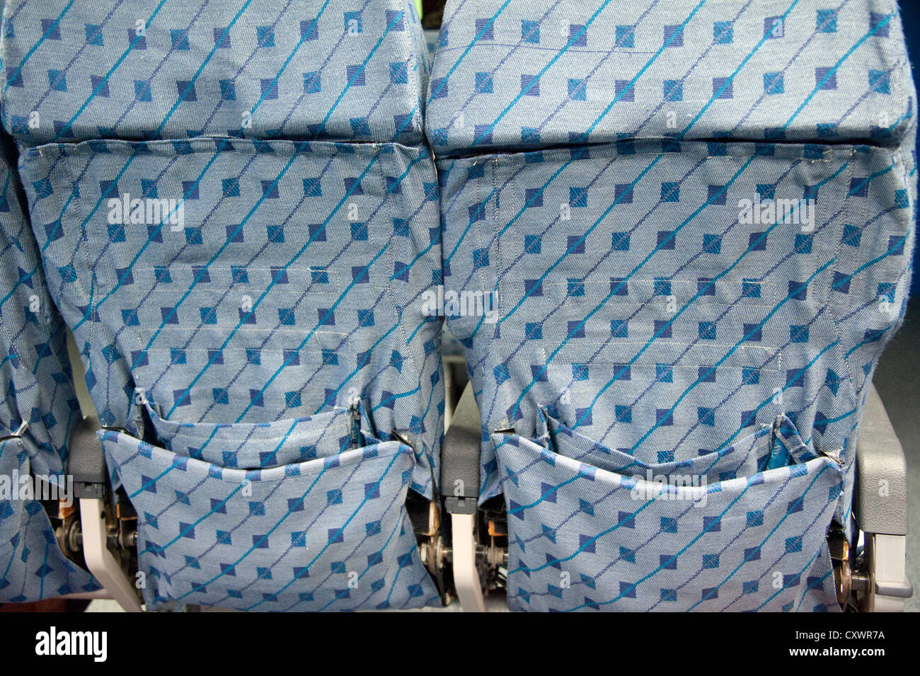 Backs of airline aircraft seats two 2 lifejacket pocket Stock Photo - Alamy