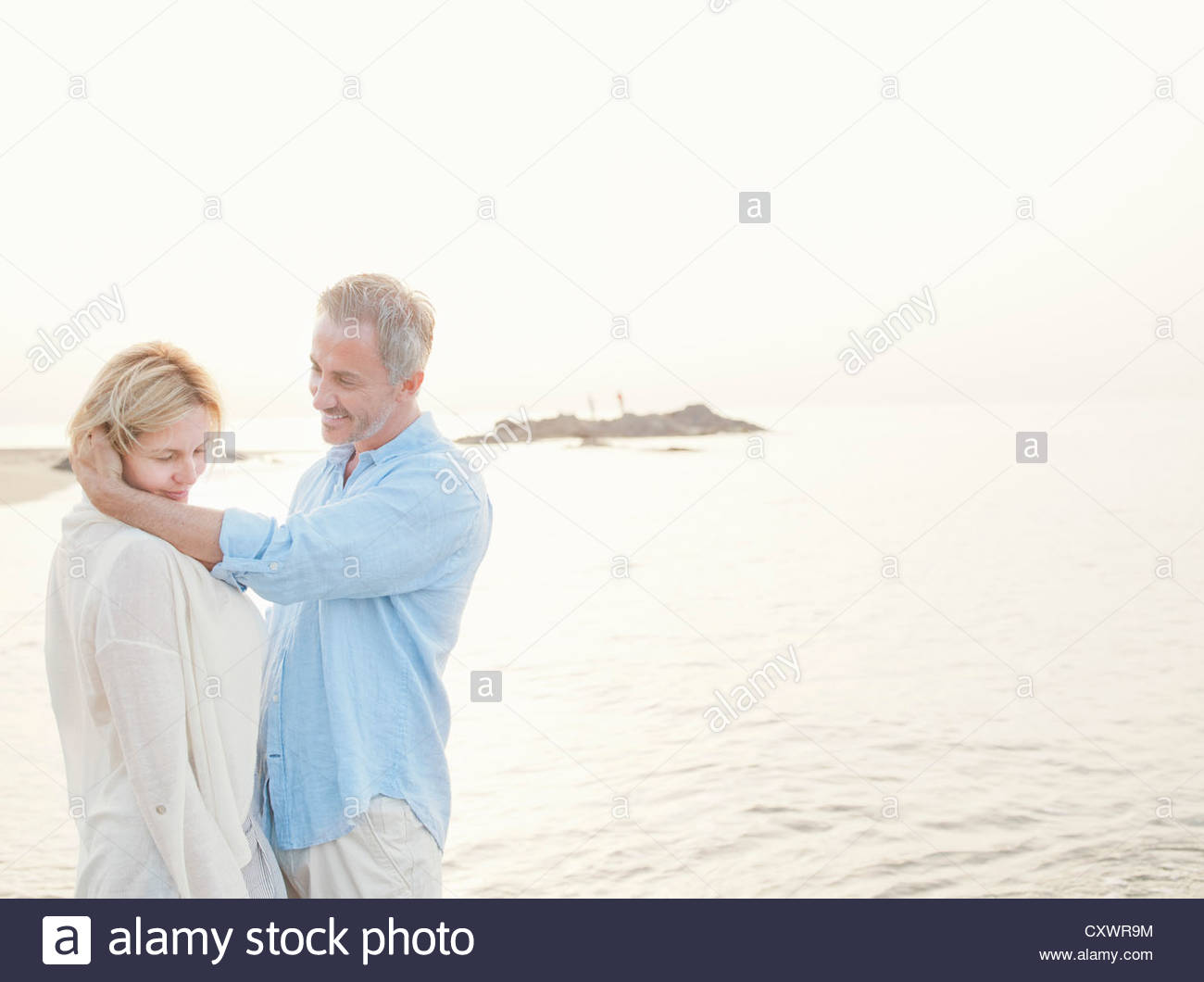 Mature Couple Hugging On Beach Stock Photos & Mature Couple Hugging On ...