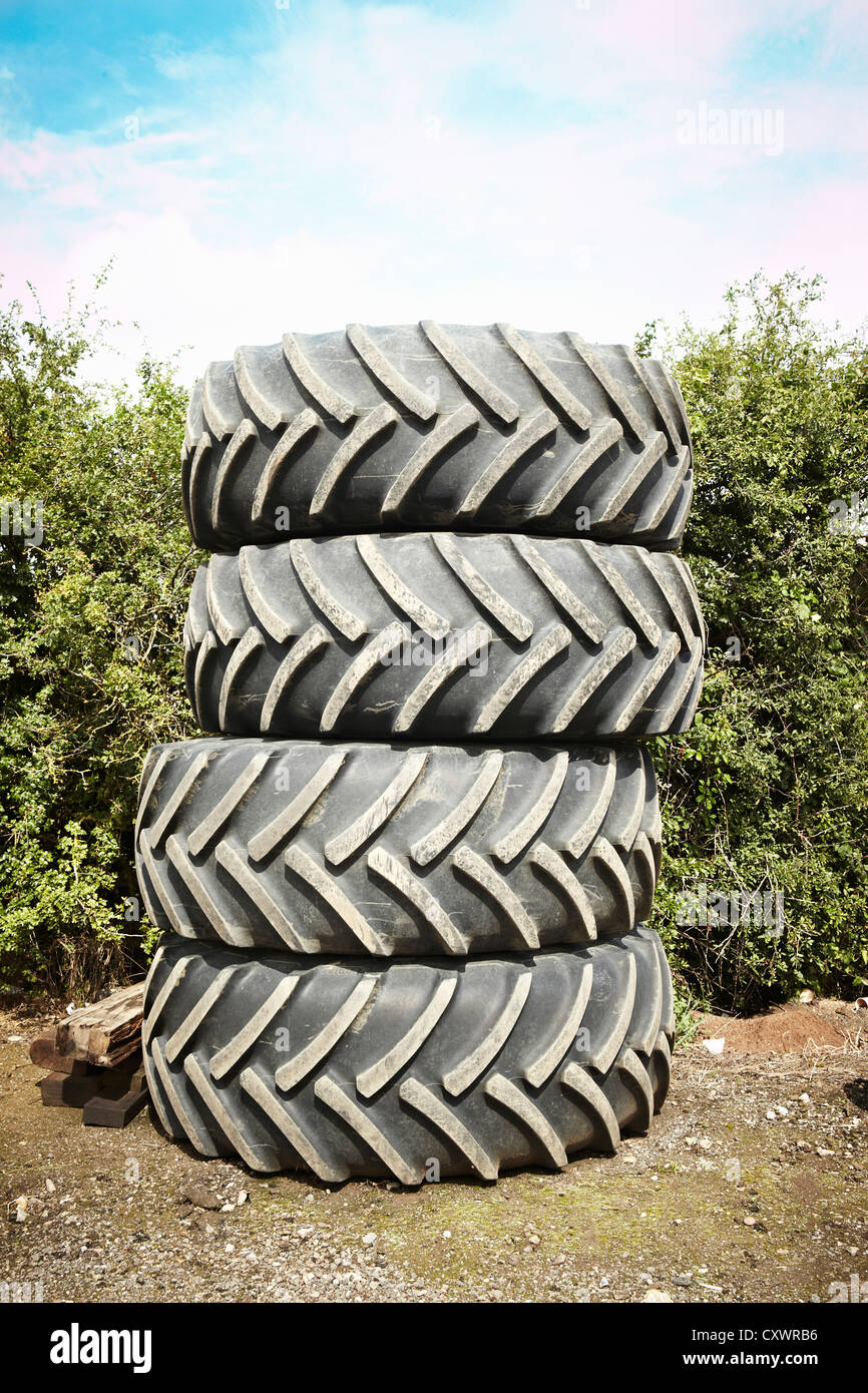 Tires stacked together in garden Stock Photo - Alamy