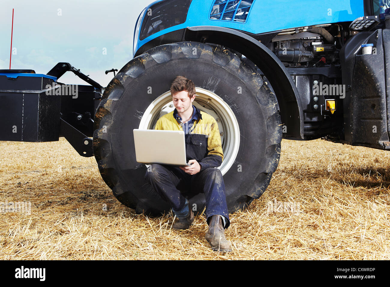 Farmer using laptop in field Stock Photo - Alamy