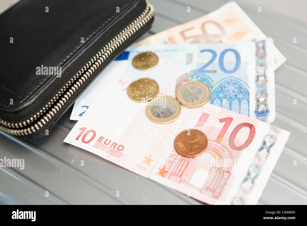 Wallet with euro notes and coins Stock Photo - Alamy
