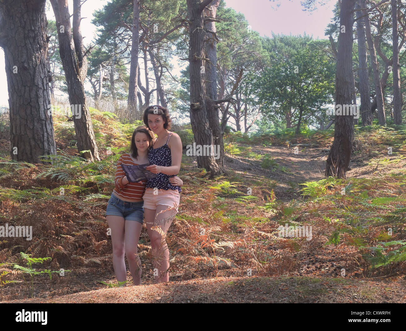 Mother and daughter reading forest map Stock Photo - Alamy