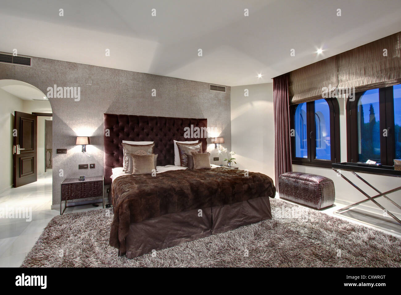 Bed and tables in modern bedroom Stock Photo - Alamy