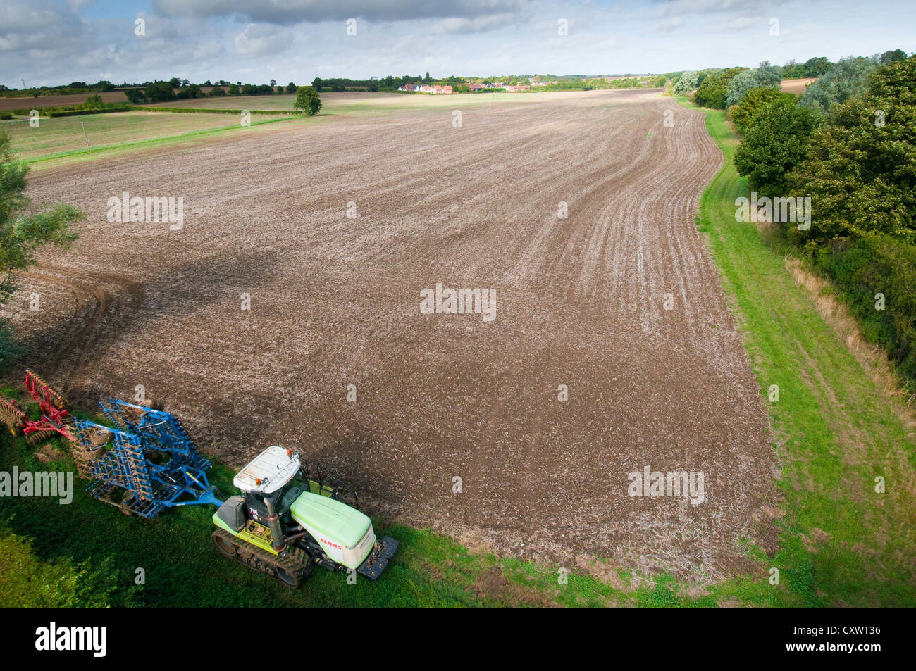 A framers field and tractor in the Essex countryside Stock Photo - Alamy