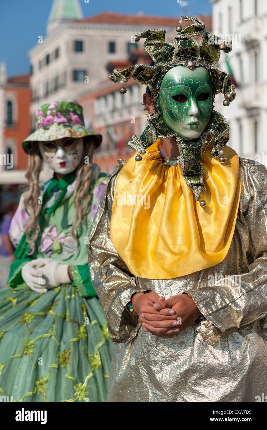 Two actors, wearing traditional carnival costumes, on the streets of ...