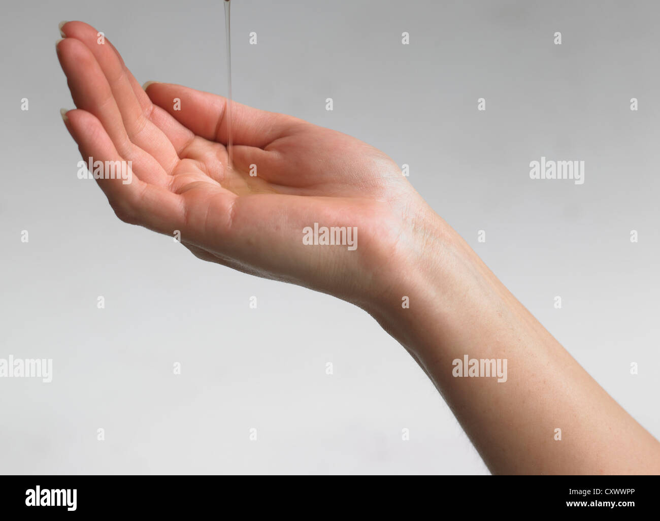 female hand cupped oil pouring Stock Photo - Alamy