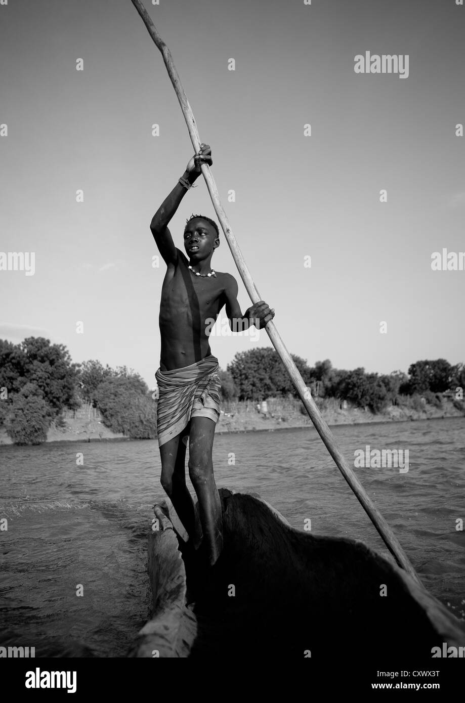 Young Boy Pushing A Boat On The Omo River, Omorate, Omo Valley ...