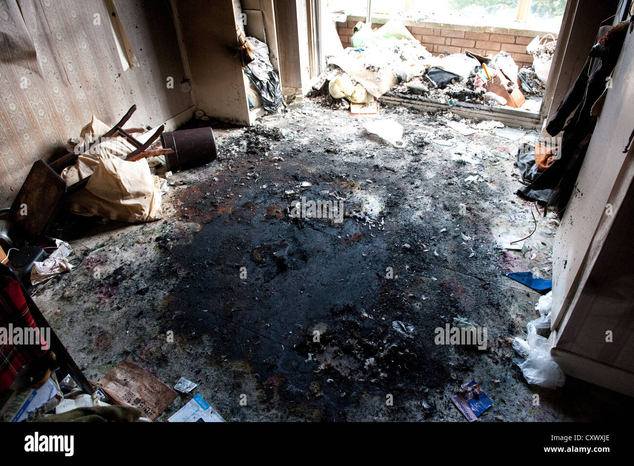 Remains of bed bedroom fire flat burnt carpet Stock Photo - Alamy