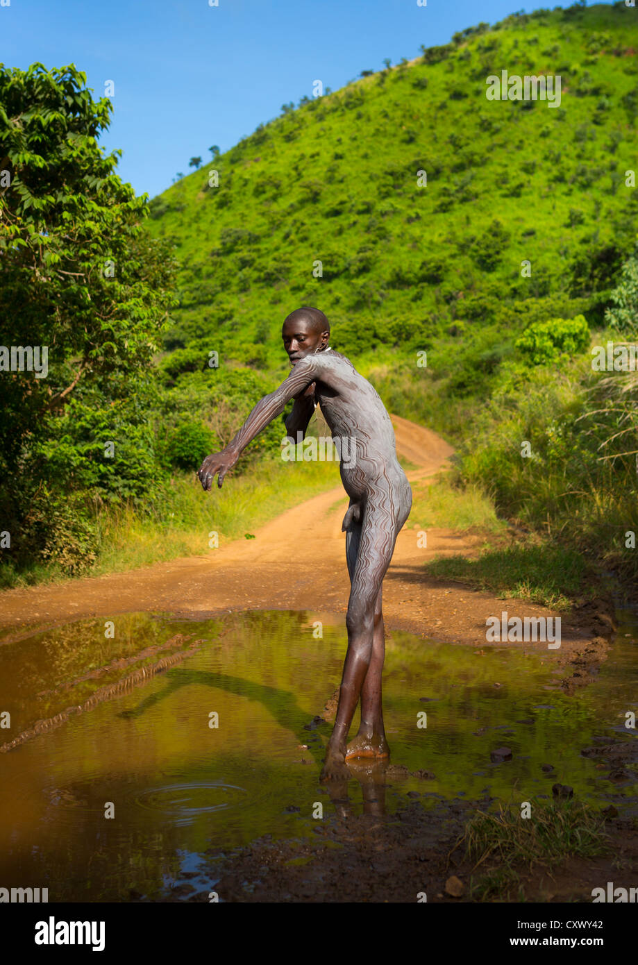 Shepherd From Suri Tribe Decorating His Body With Camouflage Paintings ...