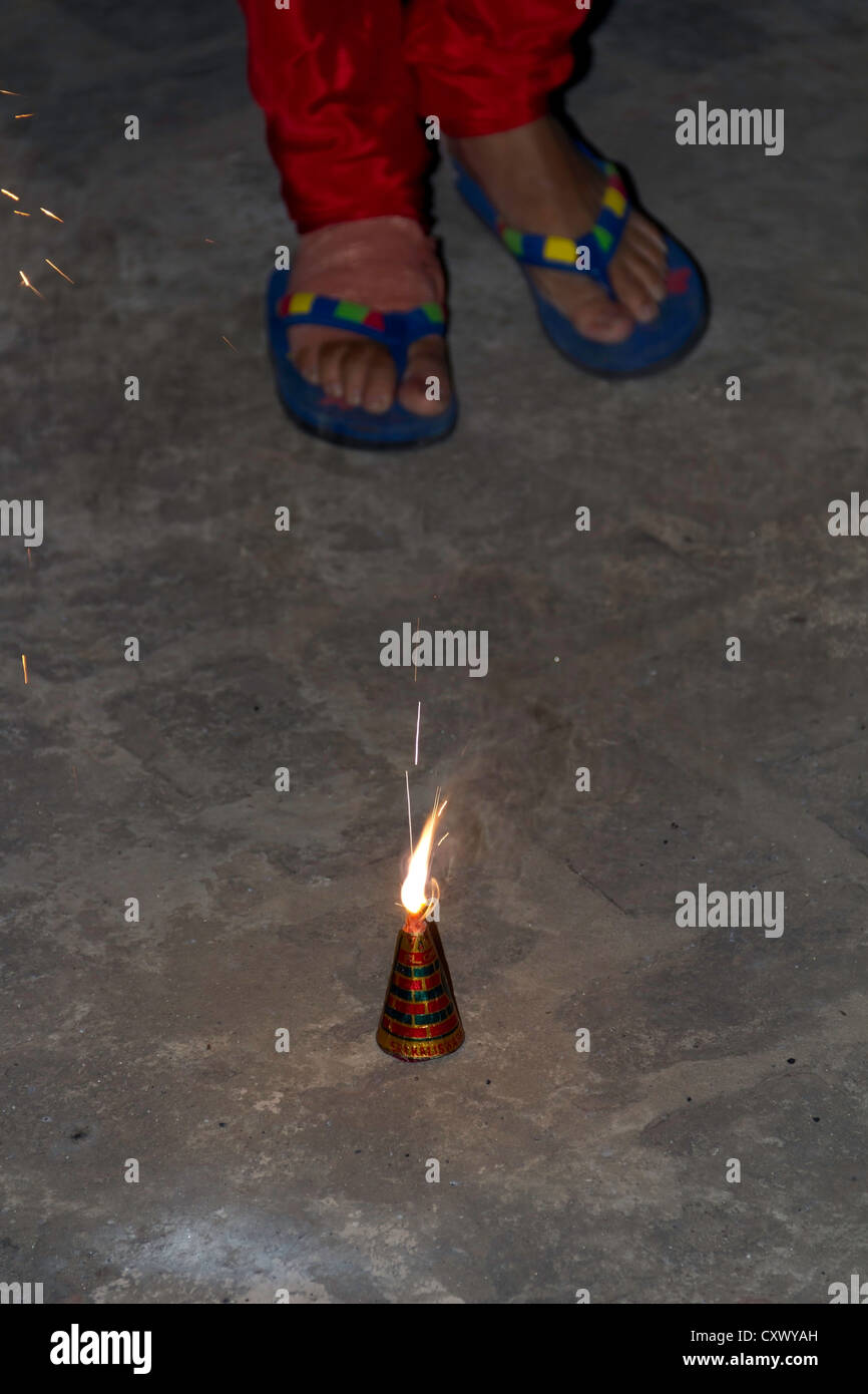 Burnt out firecracker at the feet of a lady. This fire cracker has used ...