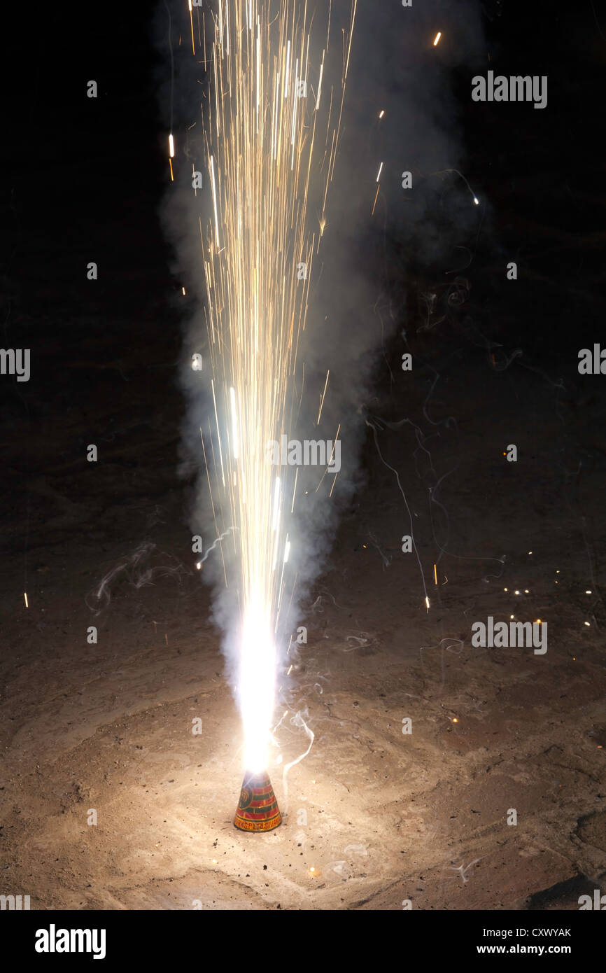 Large amount of sparks from a conical firecracker during Diwali ...