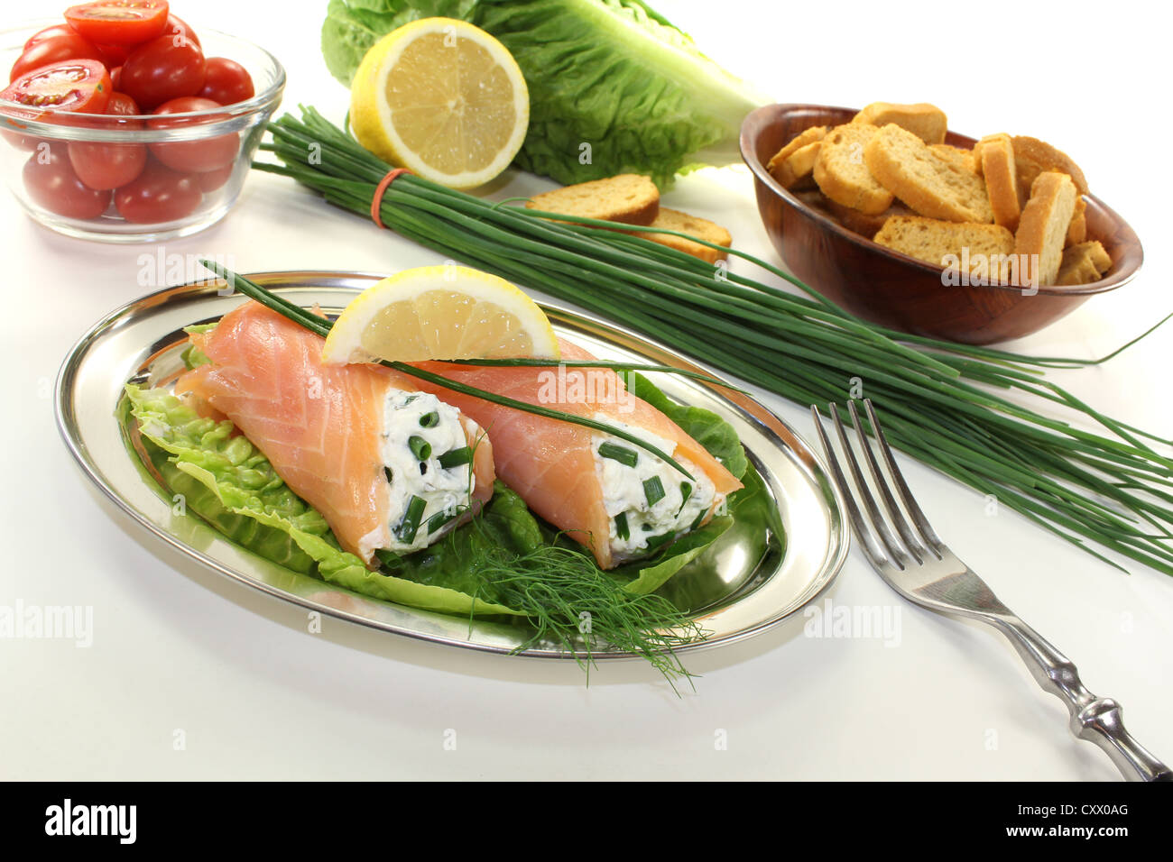 smoked salmon rolls with cream cheese, chives and a lemon slice Stock ...