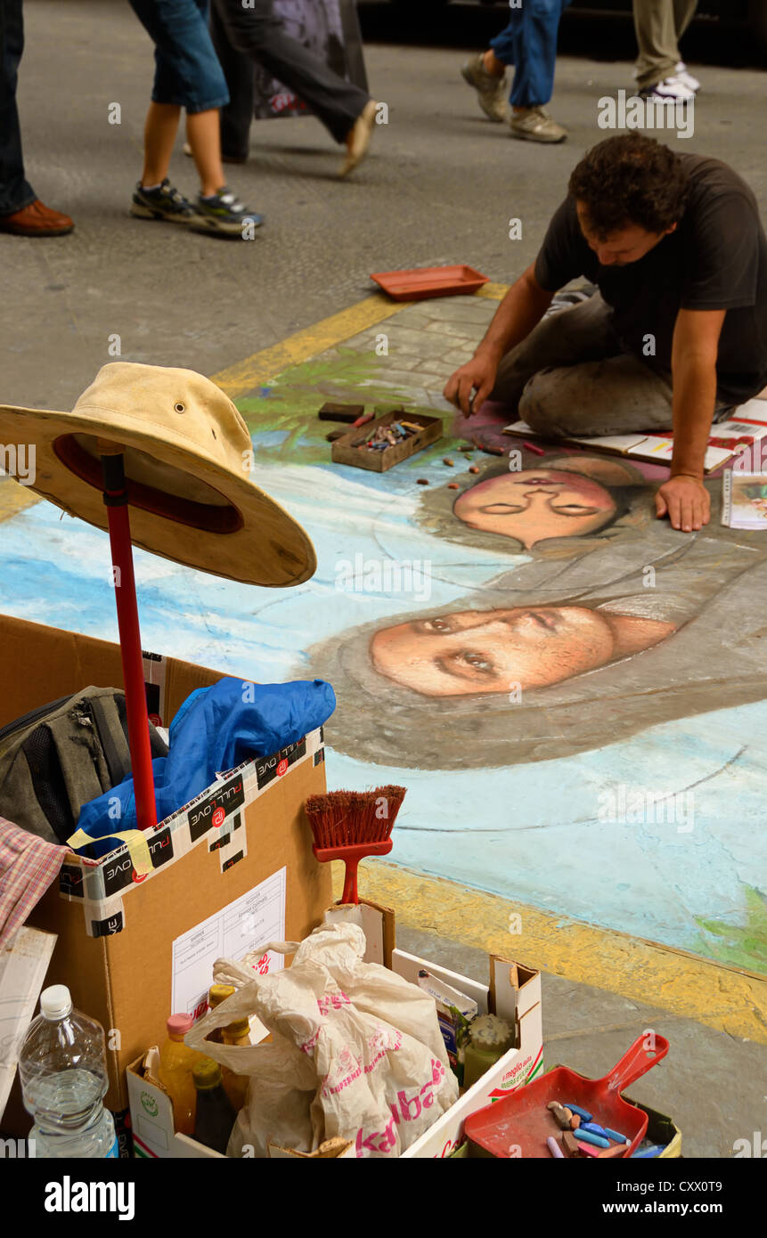 Pavement artist creating a work of art near the Palazzio Vecchio in ...