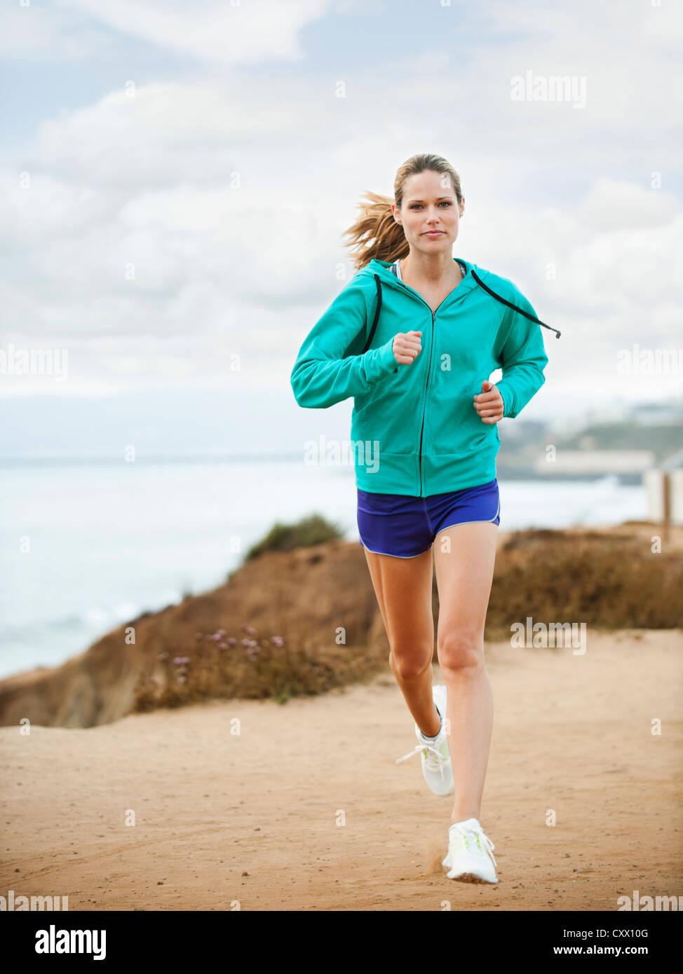 Woman trail running at coast hi-res stock photography and images - Alamy
