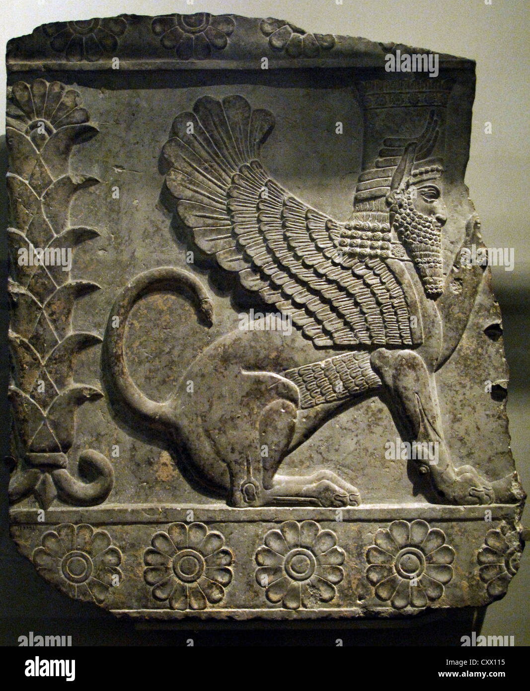 Slab with relief of a male winged sphinx wearing divine horned head ...