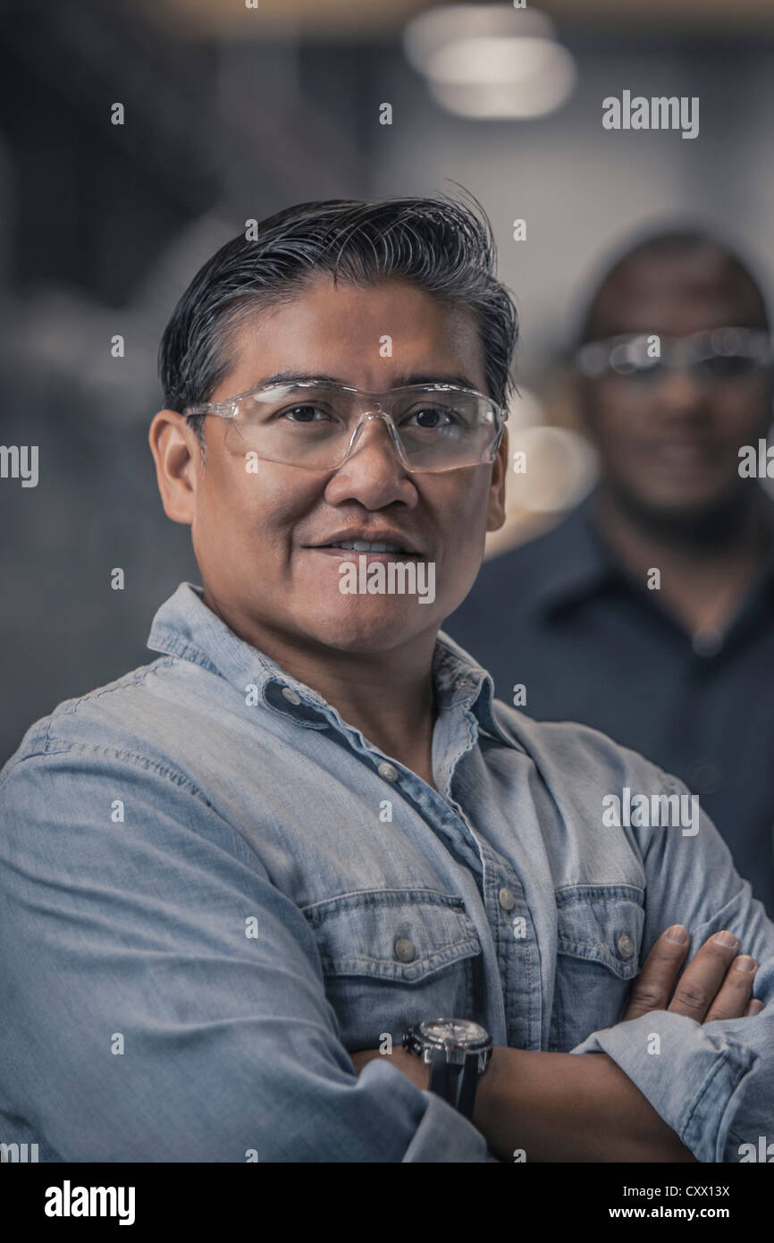 Workers standing together in factory Stock Photo - Alamy