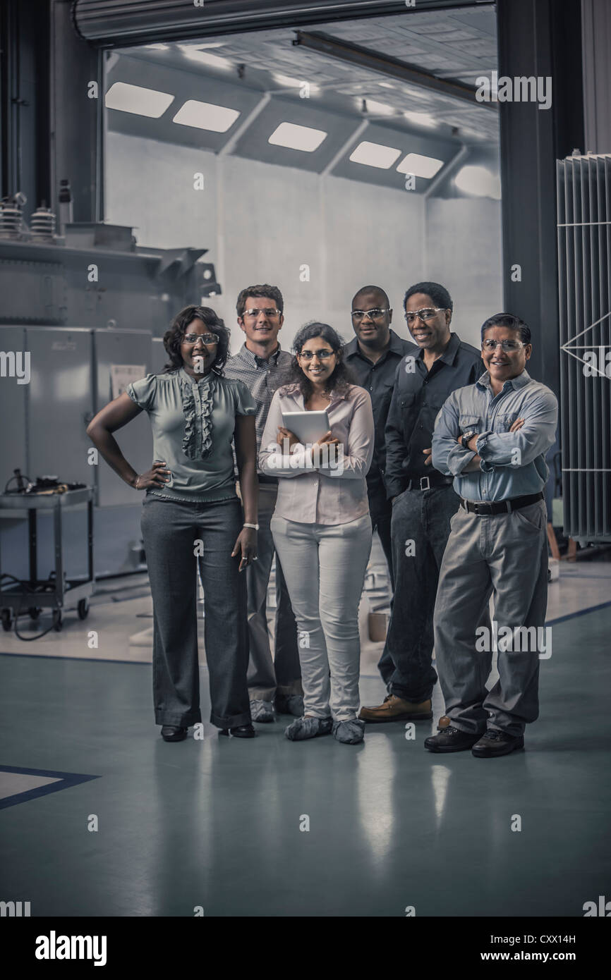 Workers standing together in factory Stock Photo - Alamy