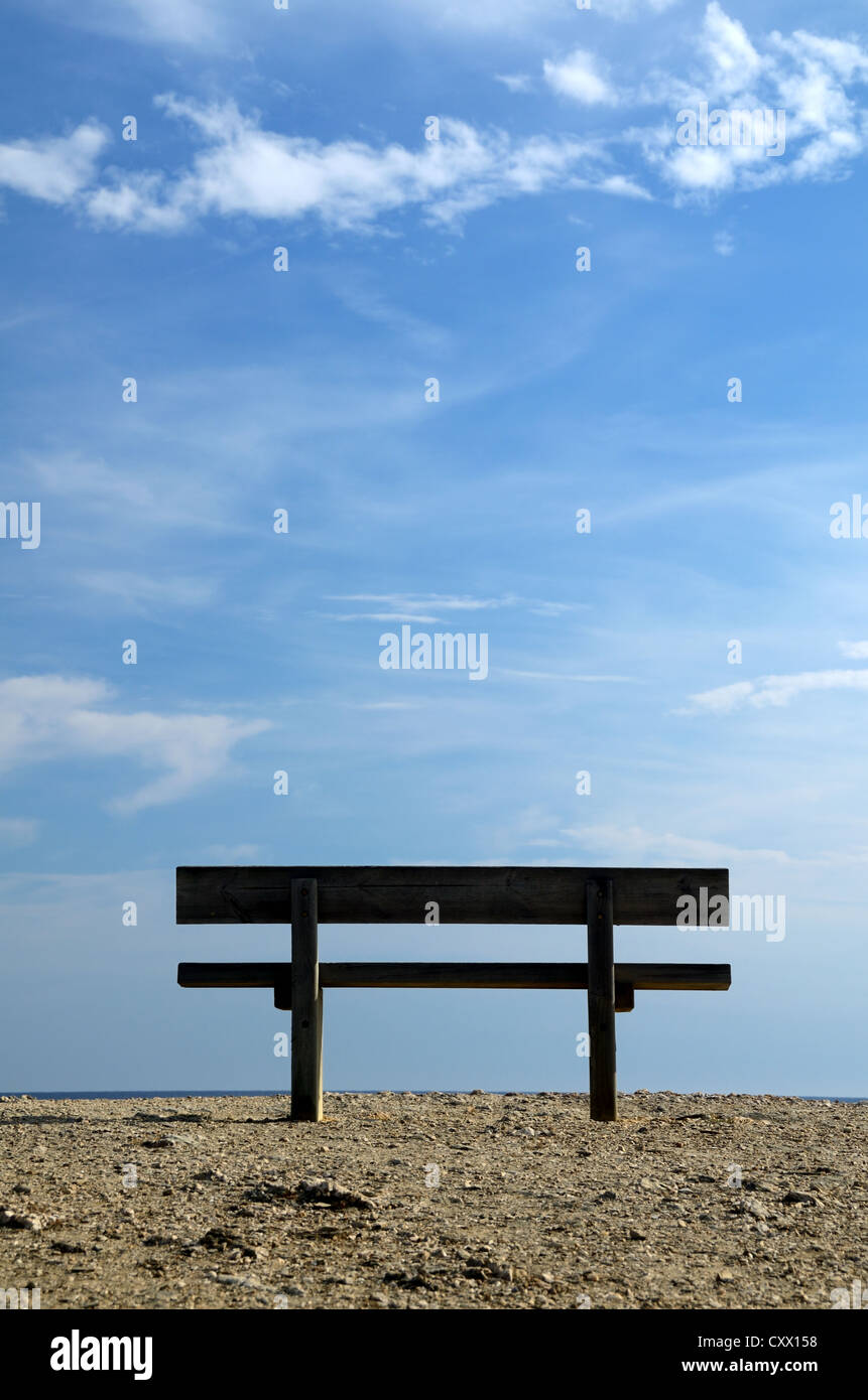 Single Park Bench on Coast or Sea Shore Silhouetted Against Blue Sky ...