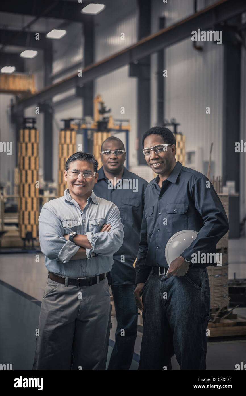 Workers standing together in factory Stock Photo - Alamy