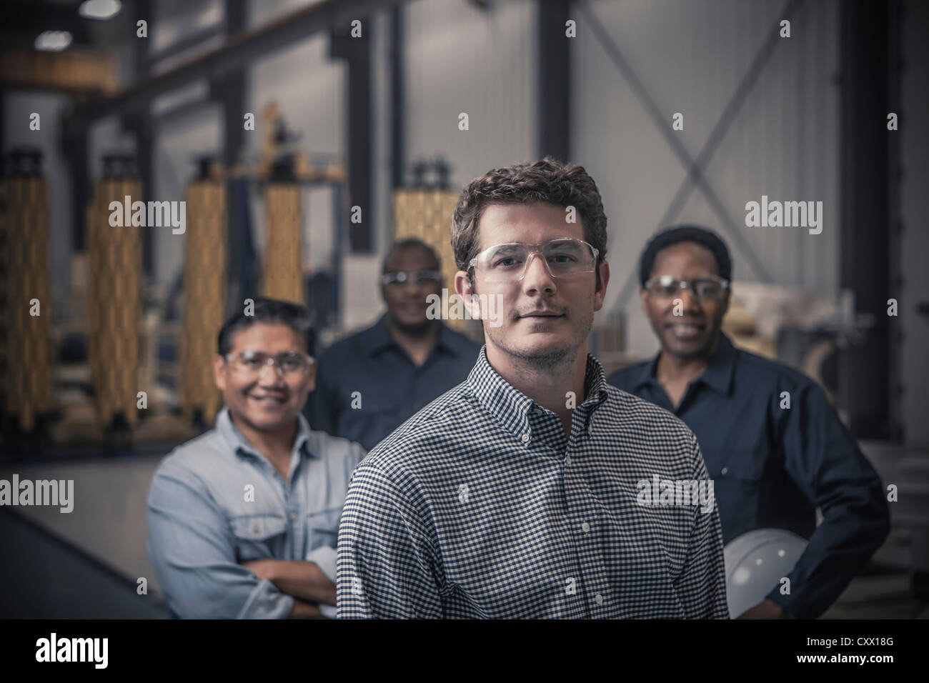 Workers standing together in factory Stock Photo - Alamy