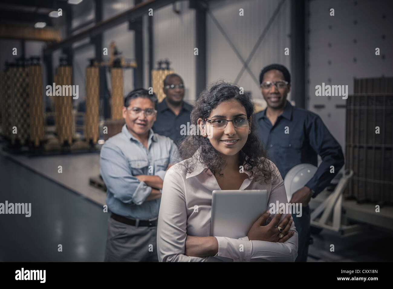 Workers standing together in factory Stock Photo - Alamy