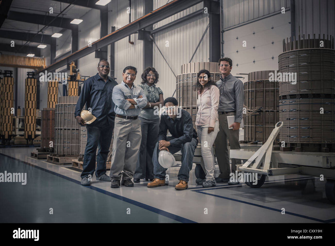 Workers standing together in factory Stock Photo - Alamy