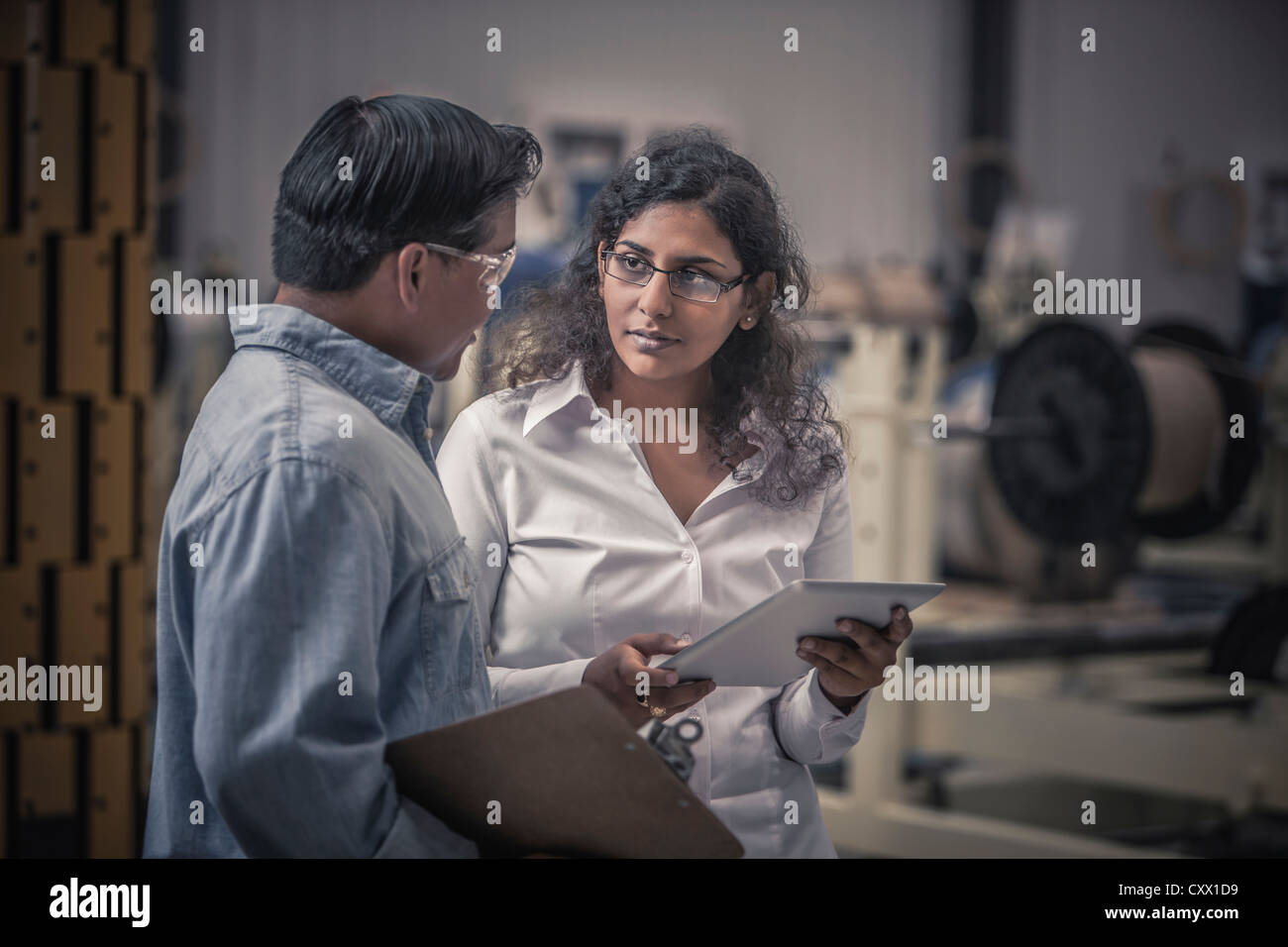 Workers talking in factory Stock Photo - Alamy