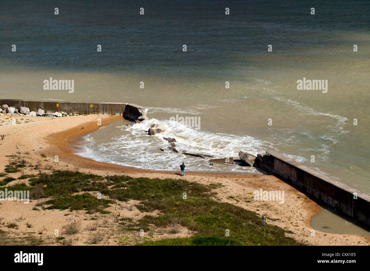 Breach in the sea Wall in a former MOD area at the base of the cliffs ...