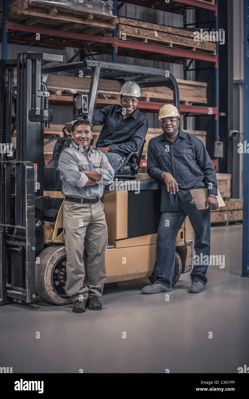Workers with forklift in factory Stock Photo - Alamy