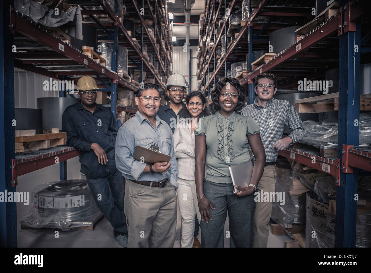 Workers standing together in factory Stock Photo - Alamy