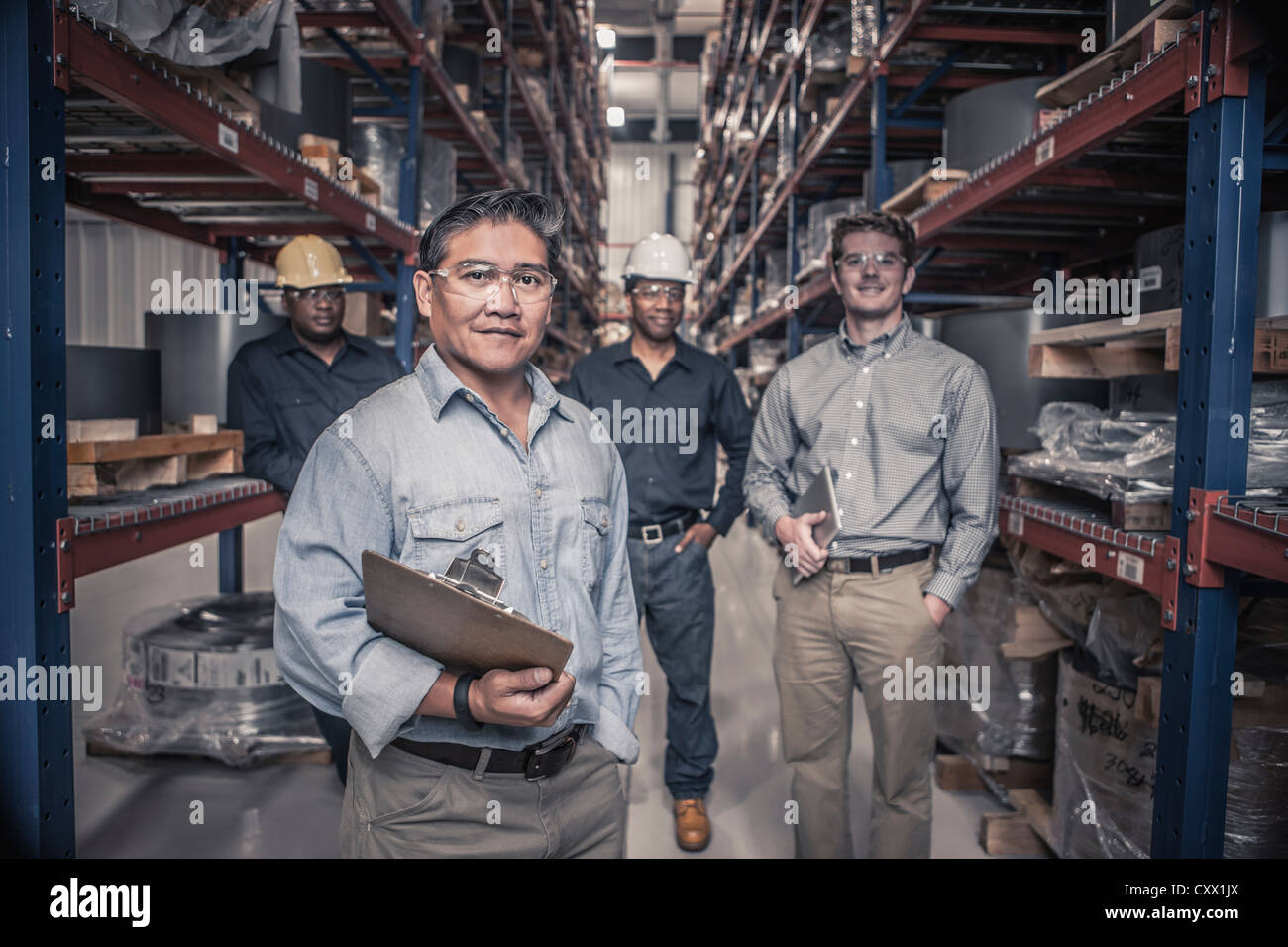 Workers standing together in factory Stock Photo - Alamy