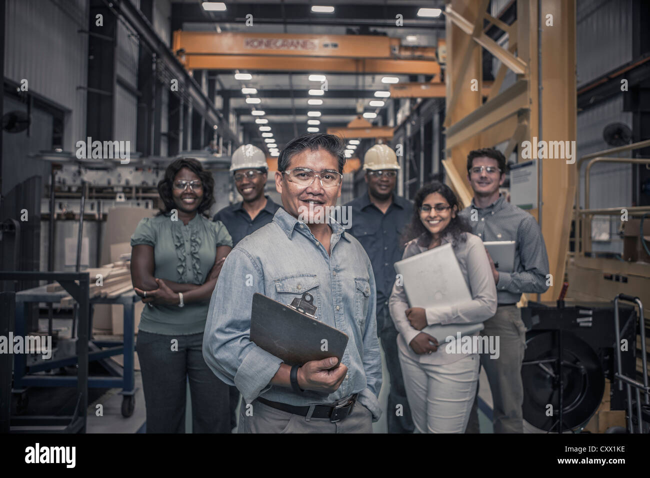 Workers standing together in factory Stock Photo - Alamy
