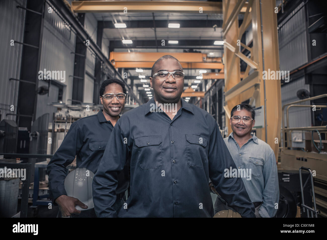 Workers standing together in factory Stock Photo - Alamy