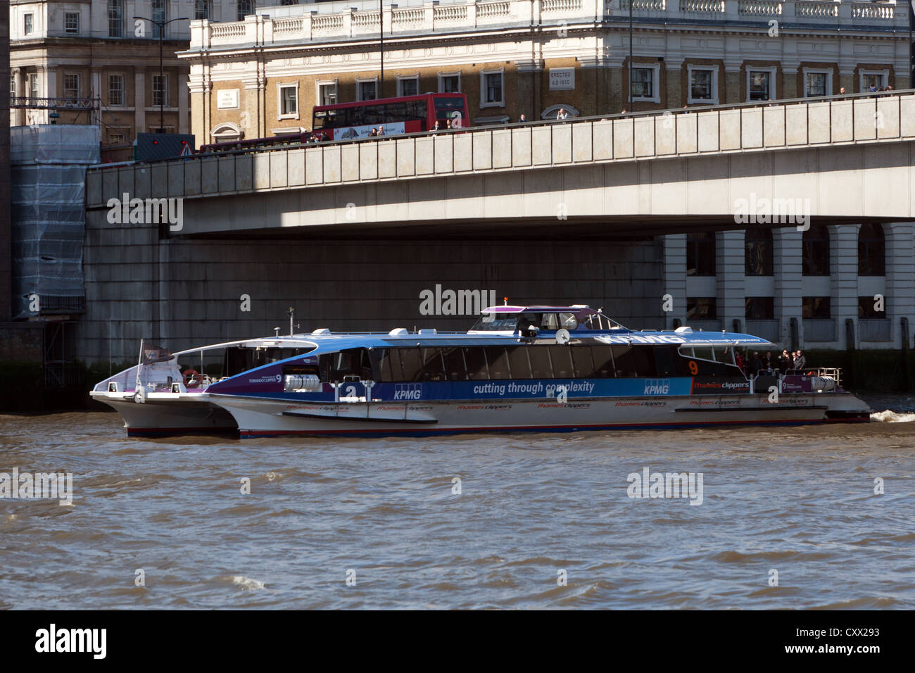 Thames Clipper commuter ferry passes under London Bridge on River ...