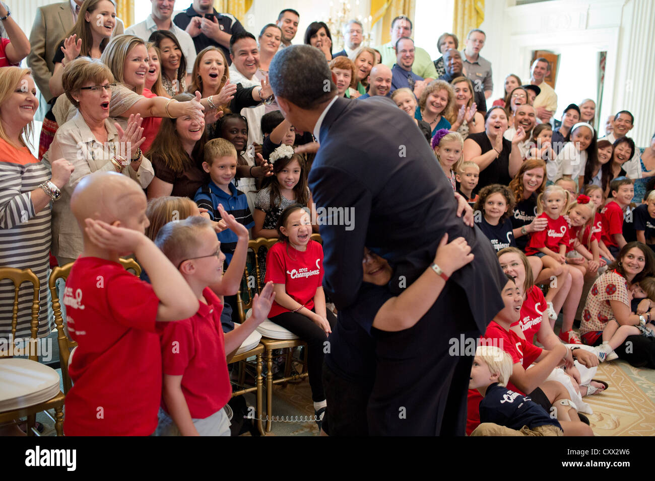 US President Barack Obama greets participants after posing for a group ...