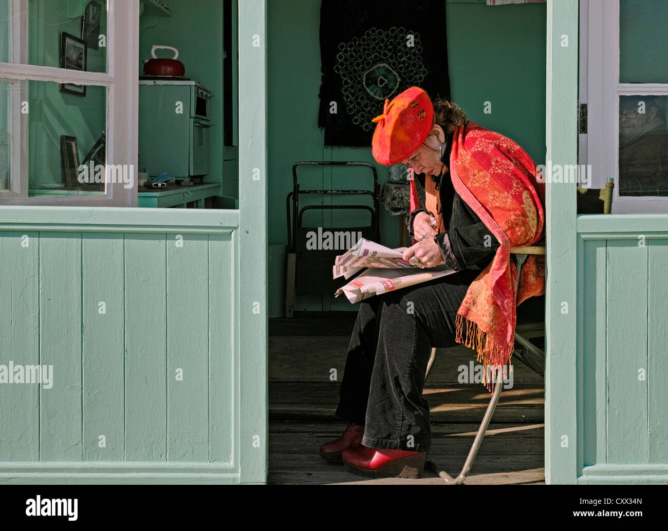 Woman reading in a Southwold beach hut Stock Photo - Alamy