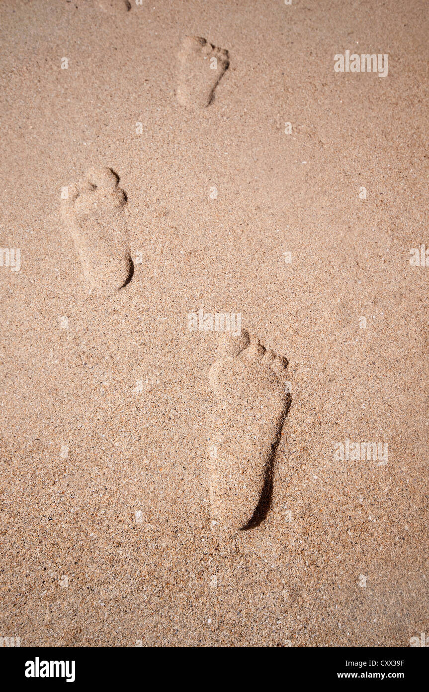 Footprints in the sand. Optical illusion makes them seem to come out of ...
