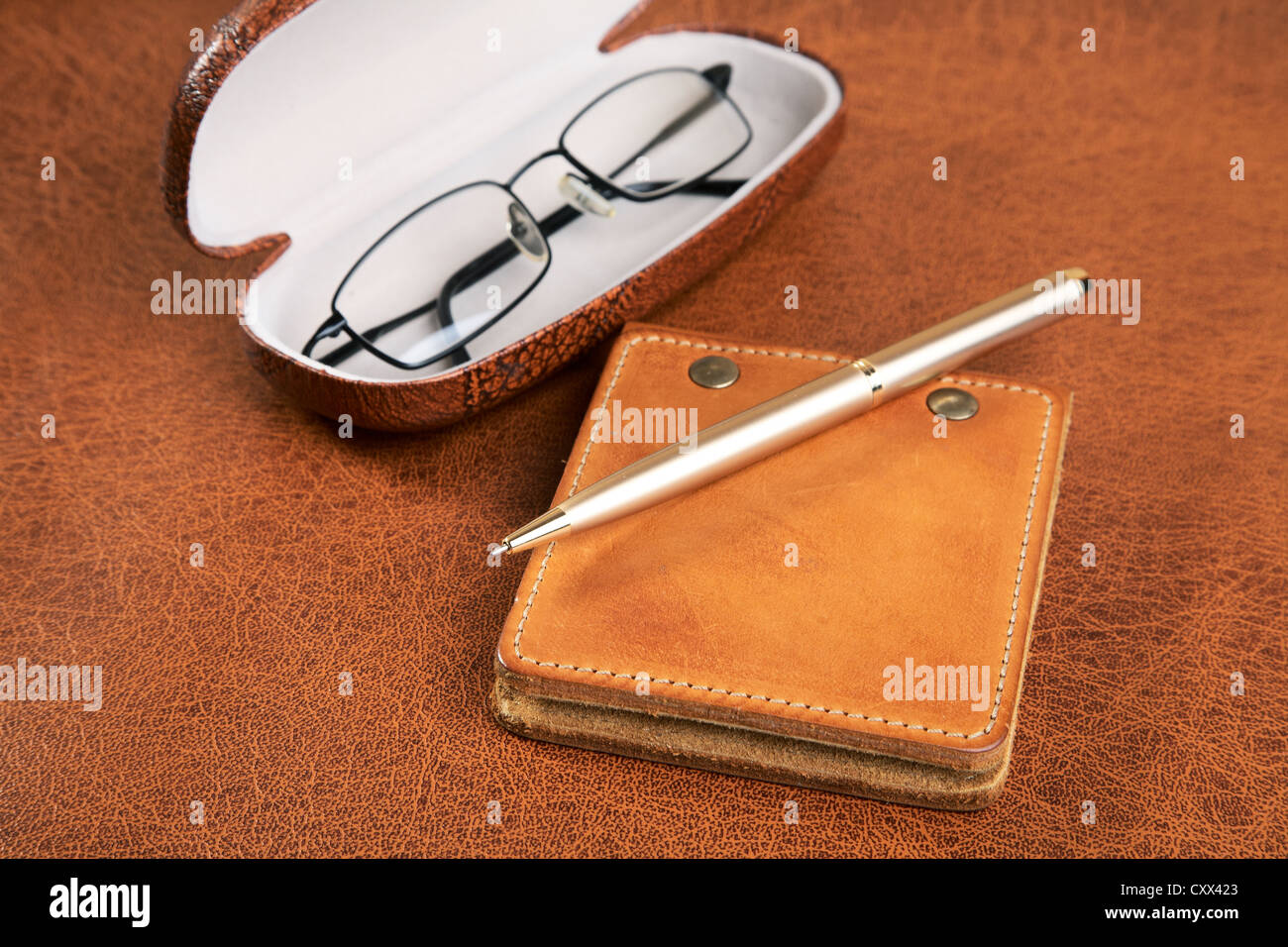 Business still-life with a pen and glasses Stock Photo - Alamy
