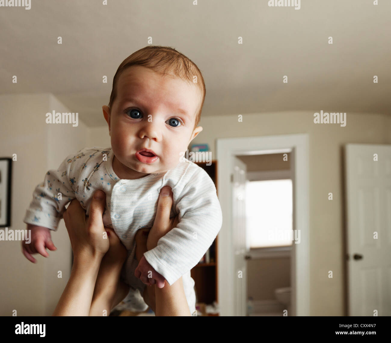 Caucasian mother lifting baby boy Stock Photo - Alamy