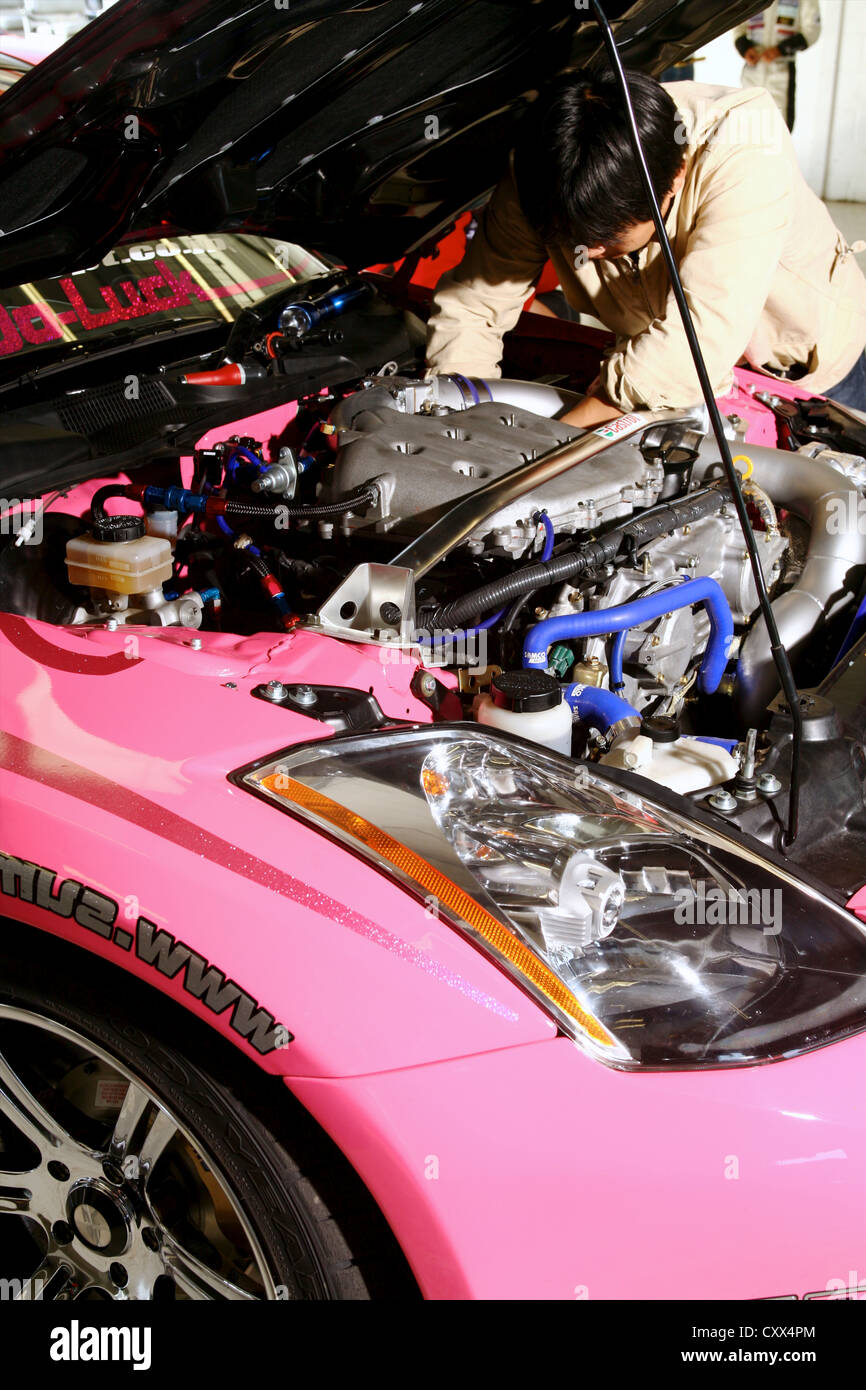 Mechanic working on engine of race car Stock Photo - Alamy