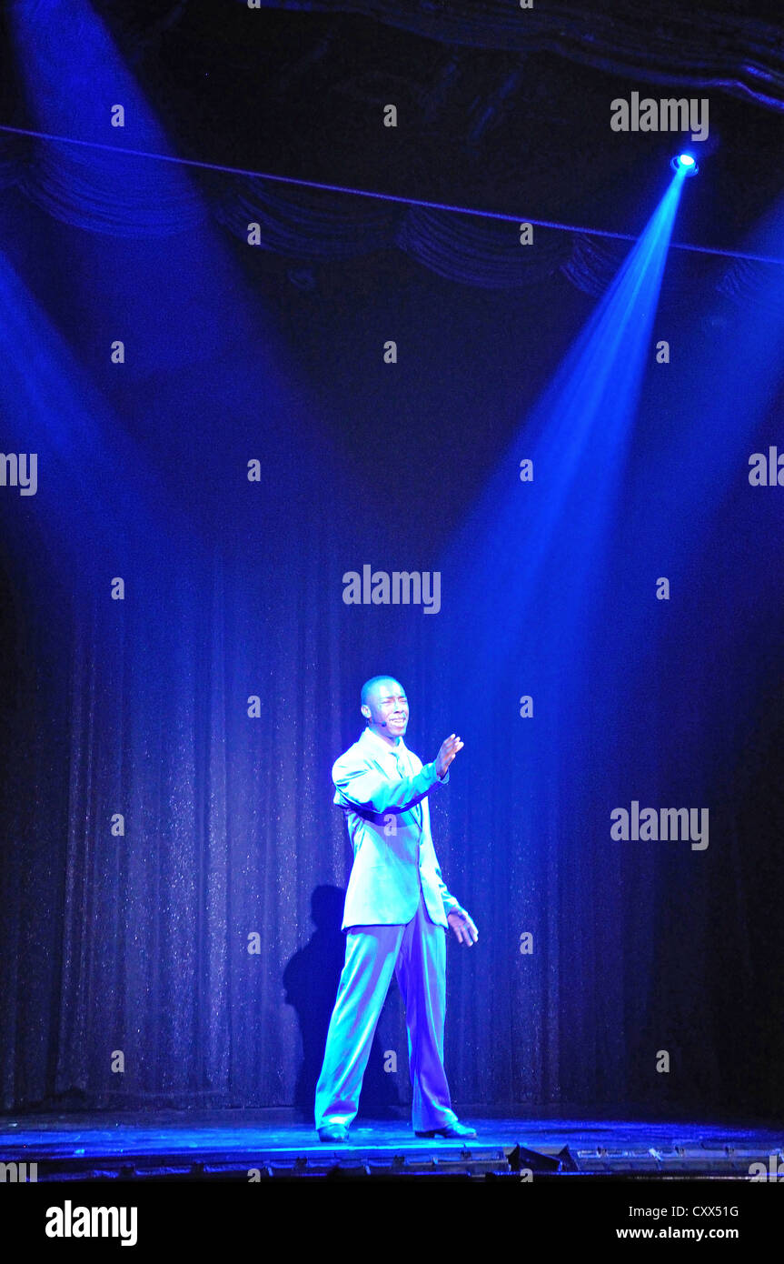 Black, male singer on stage on board Royal Caribbean 'Grandeur of the ...
