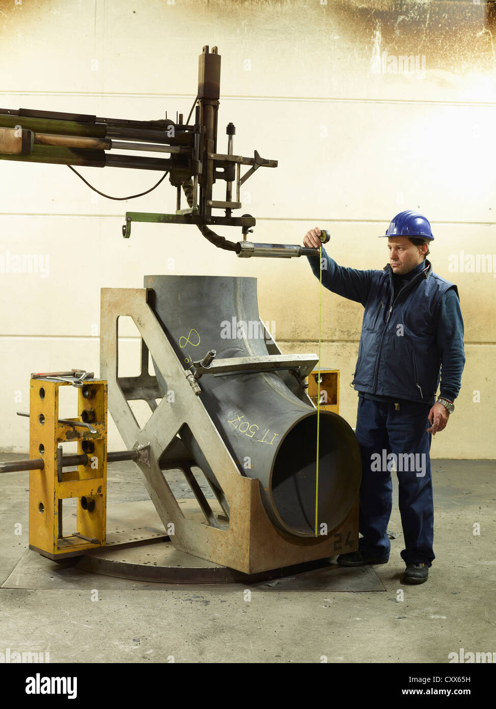 Caucasian worker working on steel pipe in factory Stock Photo - Alamy