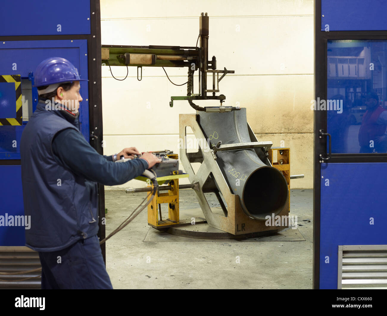 Caucasian worker working on steel pipe in factory Stock Photo - Alamy