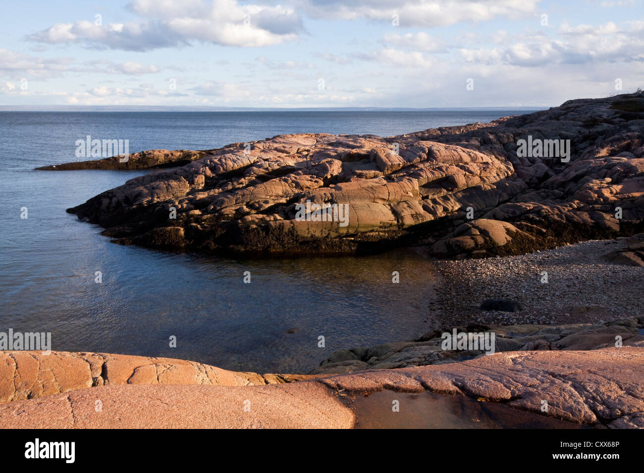 The sun sets on the rocky seashore and the intertidal zone of the St ...