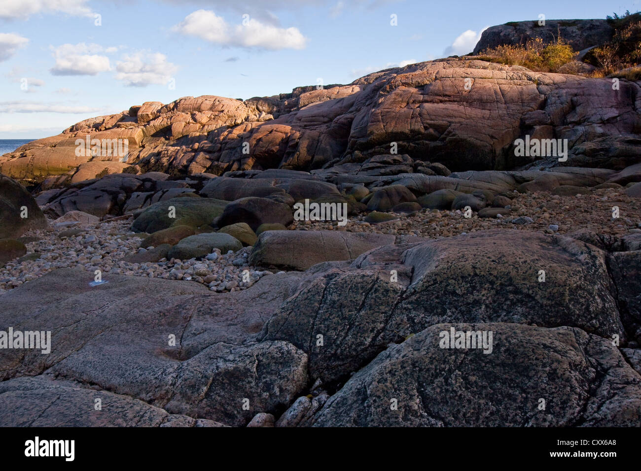 The sun sets on the rocky seashore and the intertidal zone of the St ...
