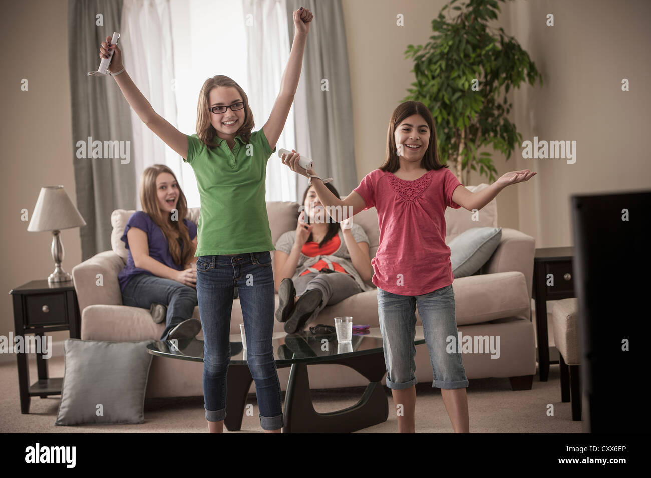Friends playing video games together Stock Photo - Alamy